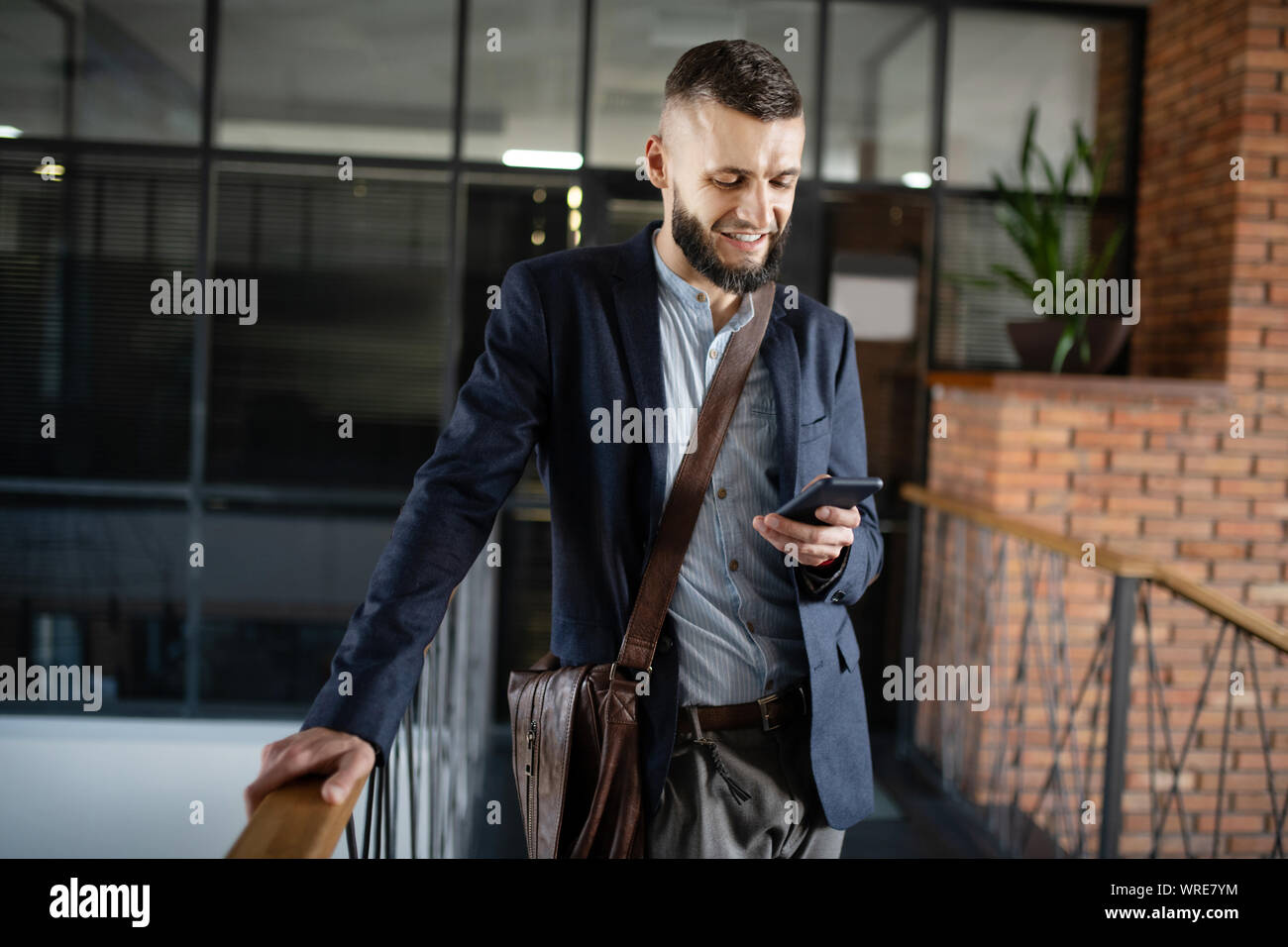 Handsome young man smiling while texting his girlfriend Stock Photo - Alamy