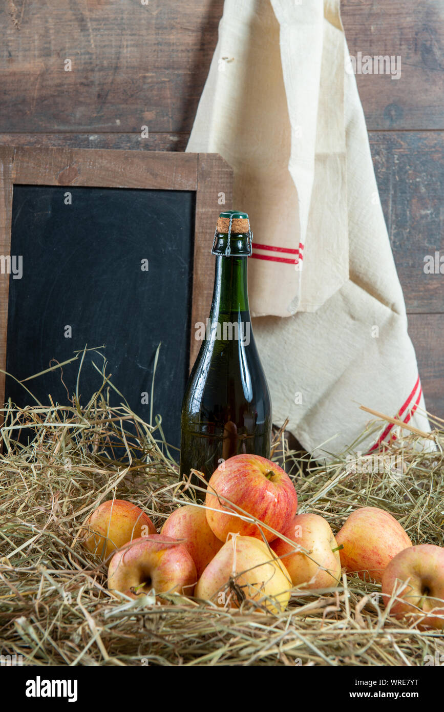 a bottle of cider with apples on the straw, and school chalkboard Stock ...
