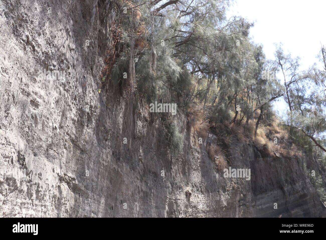 Soil erosion mountainside along the road. Weathered rock with tropical ...