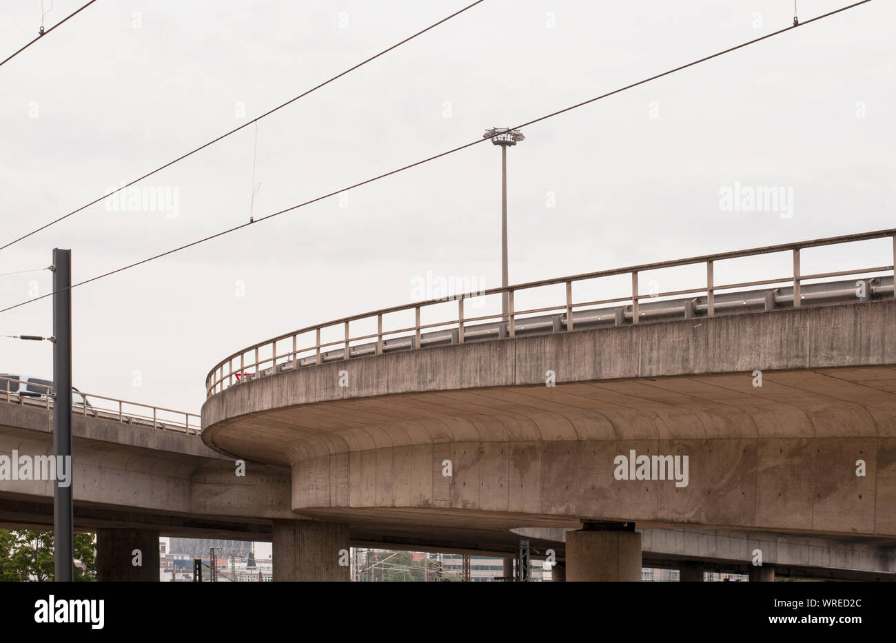 view from below to driveway to bridge over railway station in a city ...