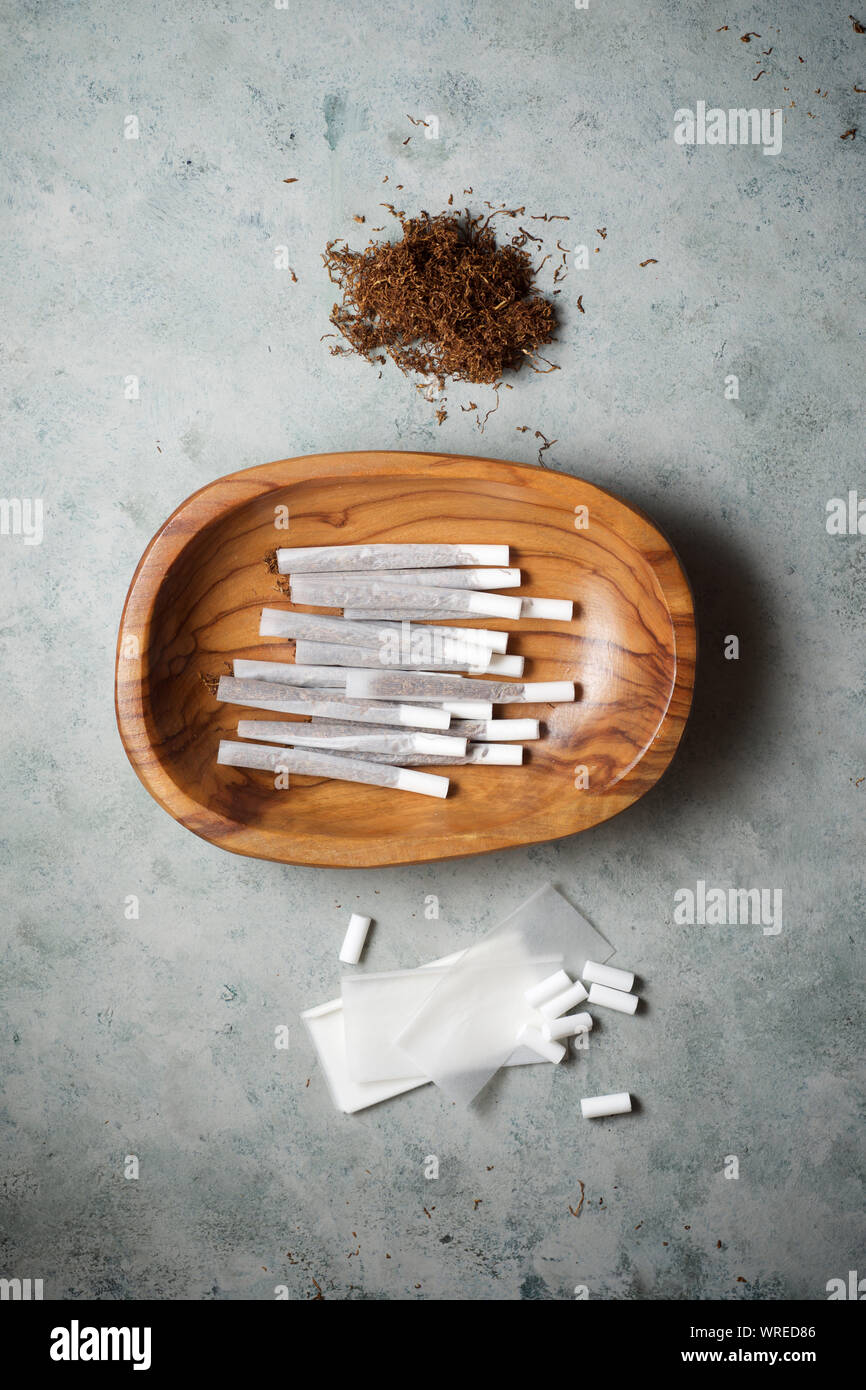 Hand rolling tobacco on a stone table Stock Photo - Alamy