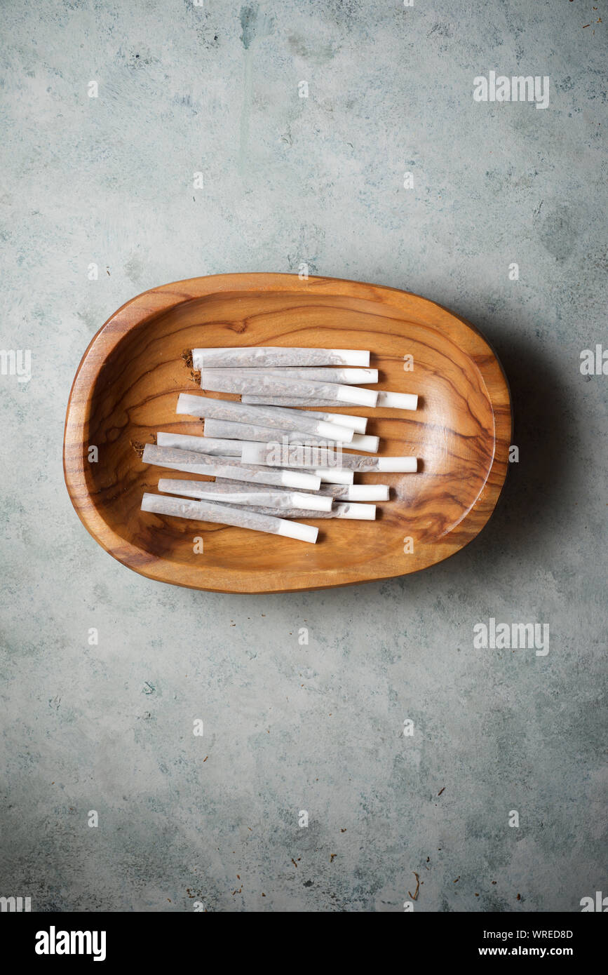 Hand rolling tobacco on a stone table Stock Photo - Alamy