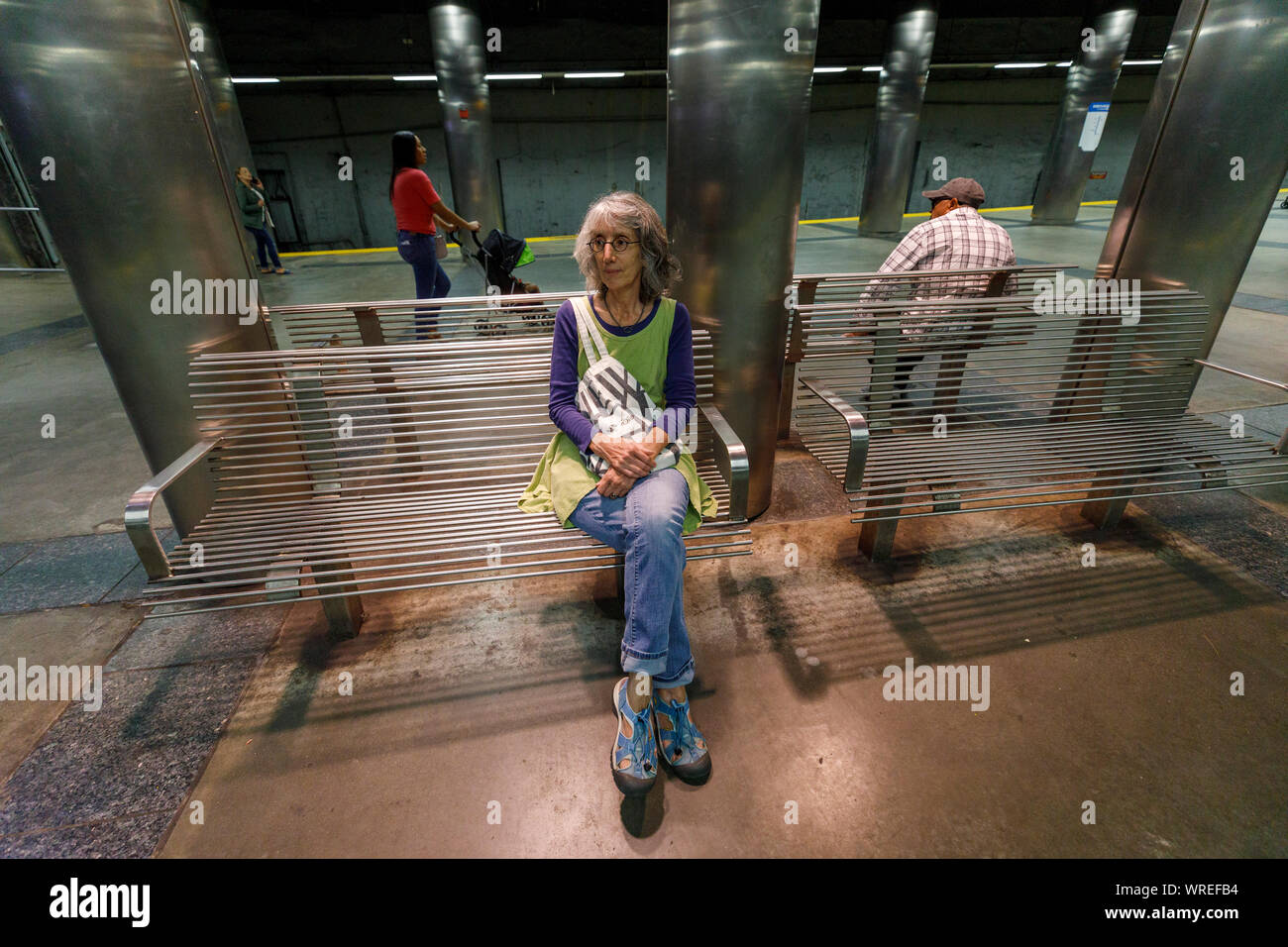 Woman waiting on the Blue Line subway platform, Maverick Square, East ...