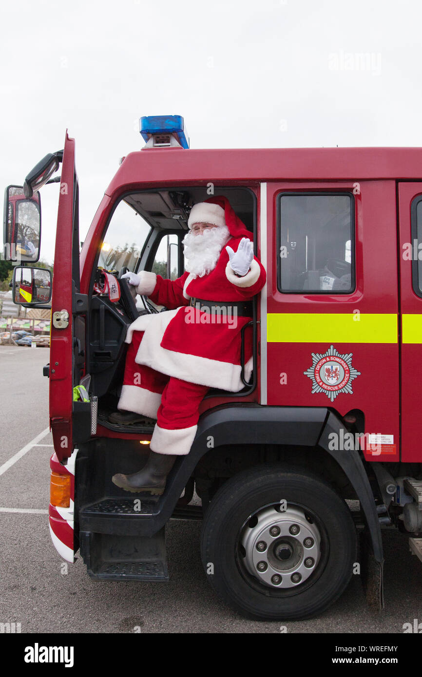 Father Christmas Santa Claus arriving in a fire engine Stock Photo - Alamy