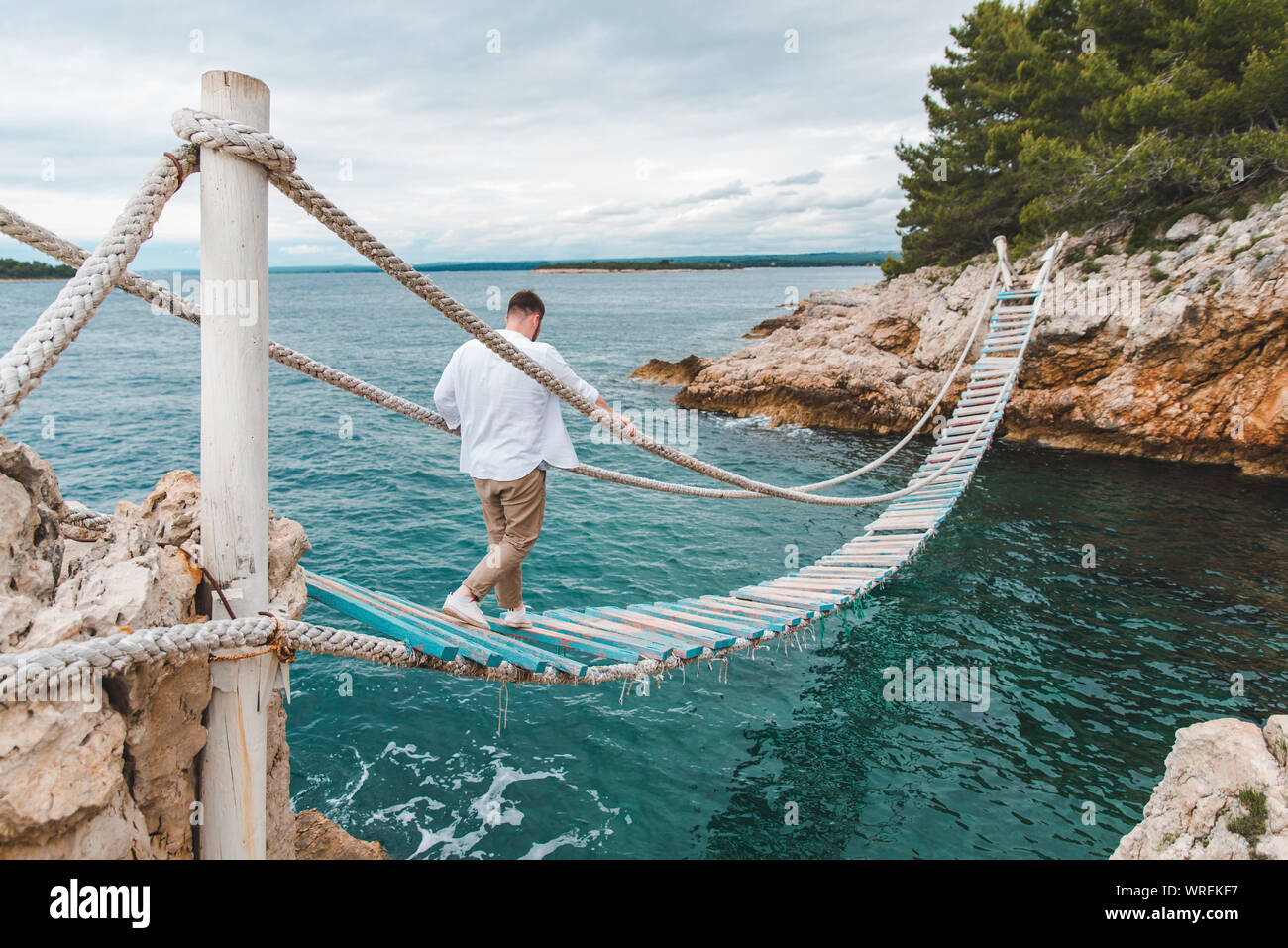 Man woman crossing rope bridge hi-res stock photography and images - Alamy