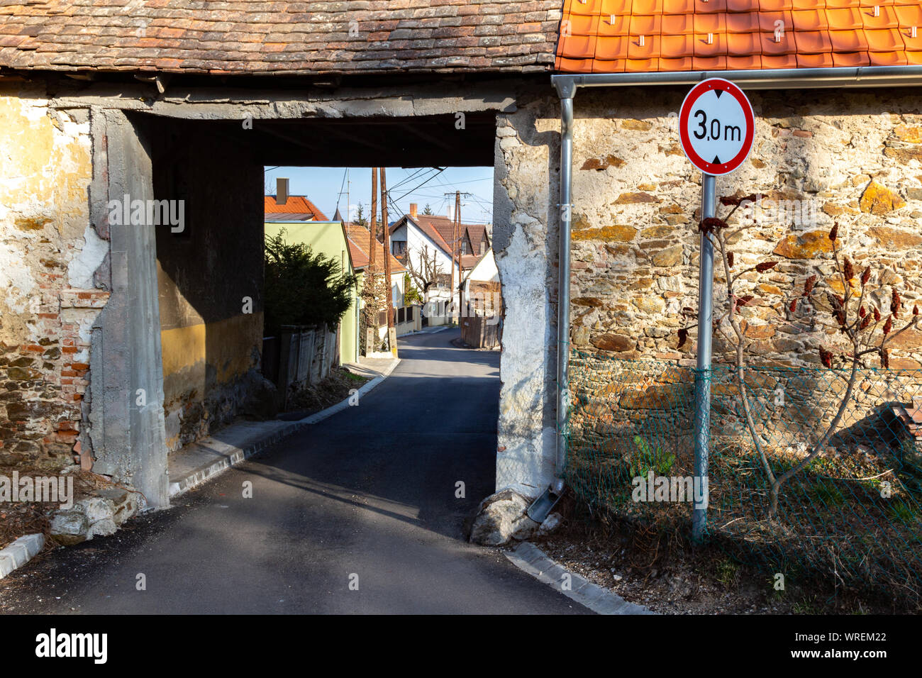 Passage through old building with traffic sign saying vehicles of ...