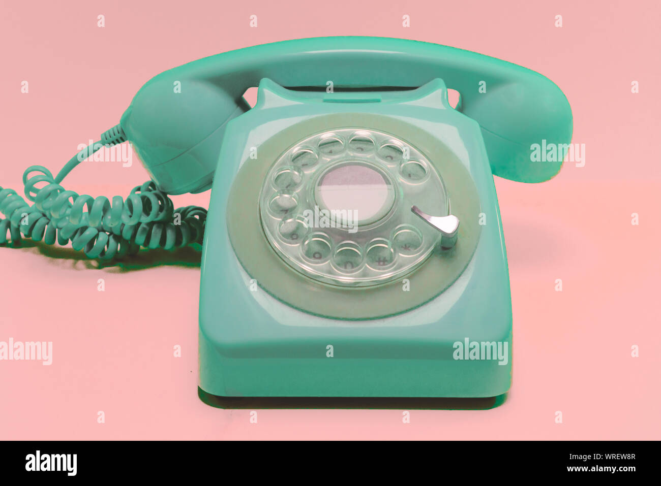 Old Fashioned Rotary Telephone in Turquoise With Coral Background Stock ...
