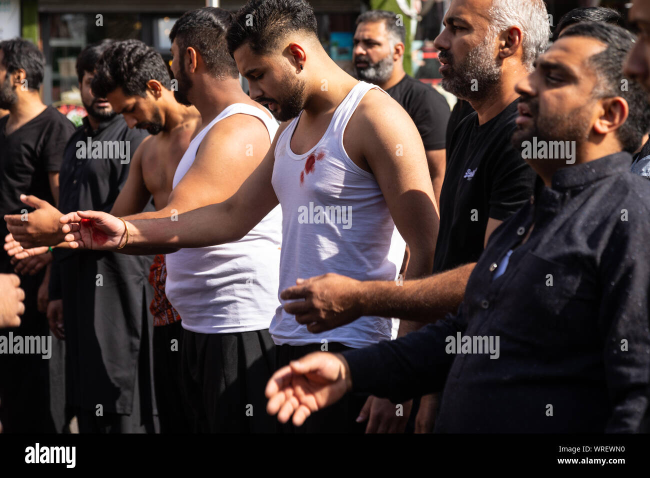 Shia men and young boys emotionally beating their chests in the Ashura ...