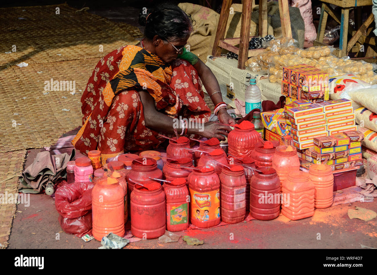 Crouching Indian woman selling sandal paste Stock Photo - Alamy