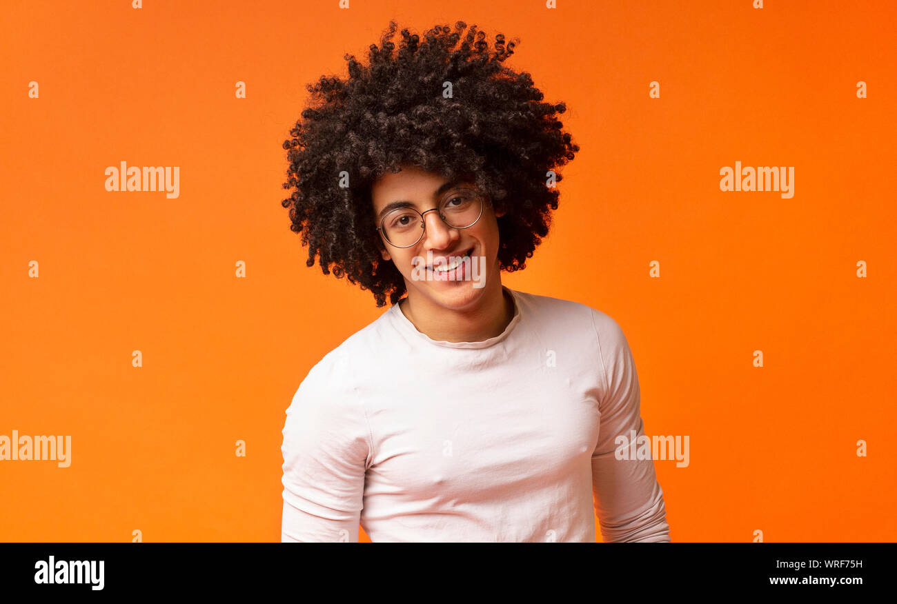 Portrait of cheerful millennial black guy with bushy hair Stock Photo ...