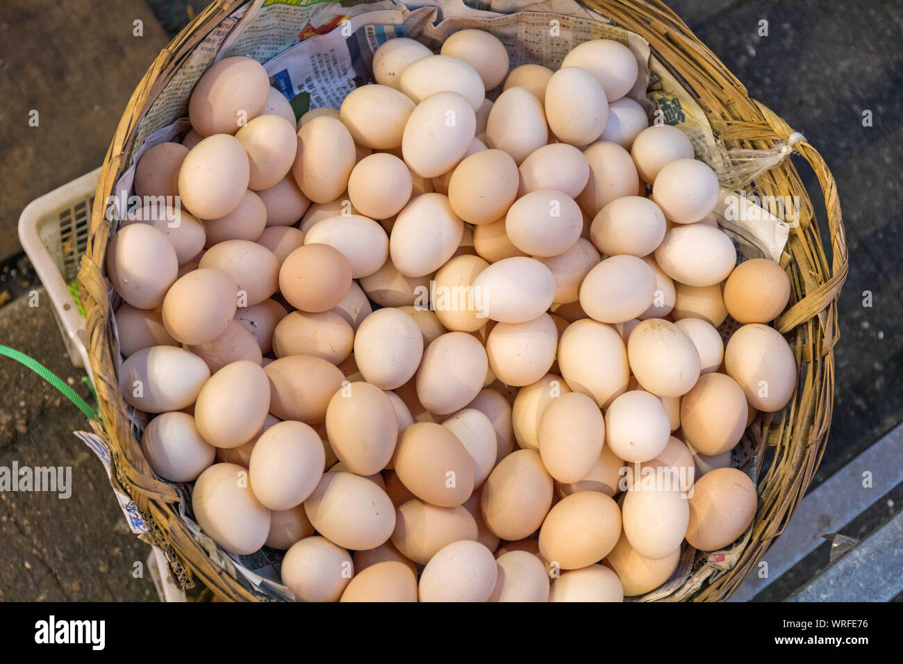 Bunch of Eggs in One Big Basket Stock Photo - Alamy