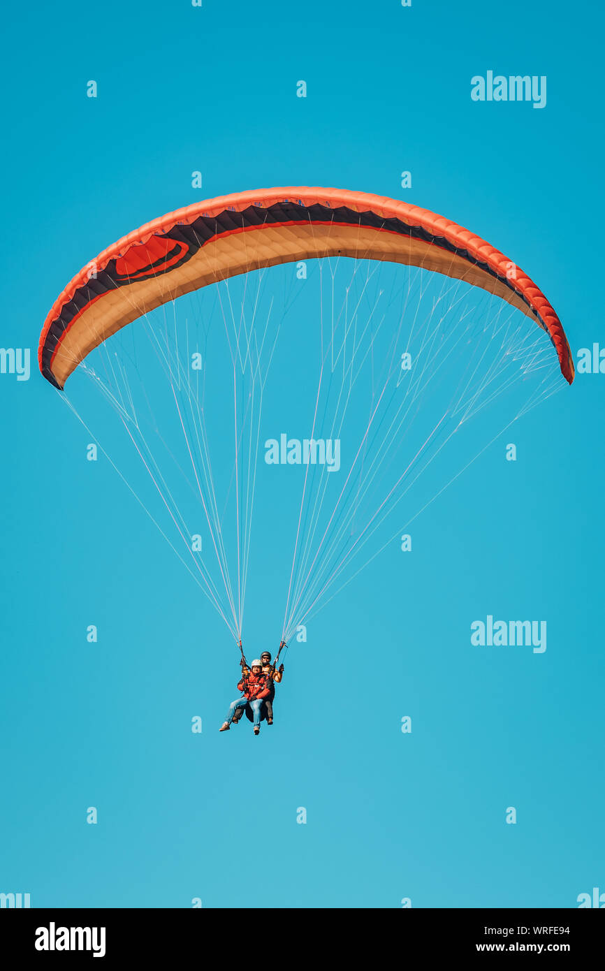 Colorful paraglider on blue bright sky close-up Stock Photo - Alamy