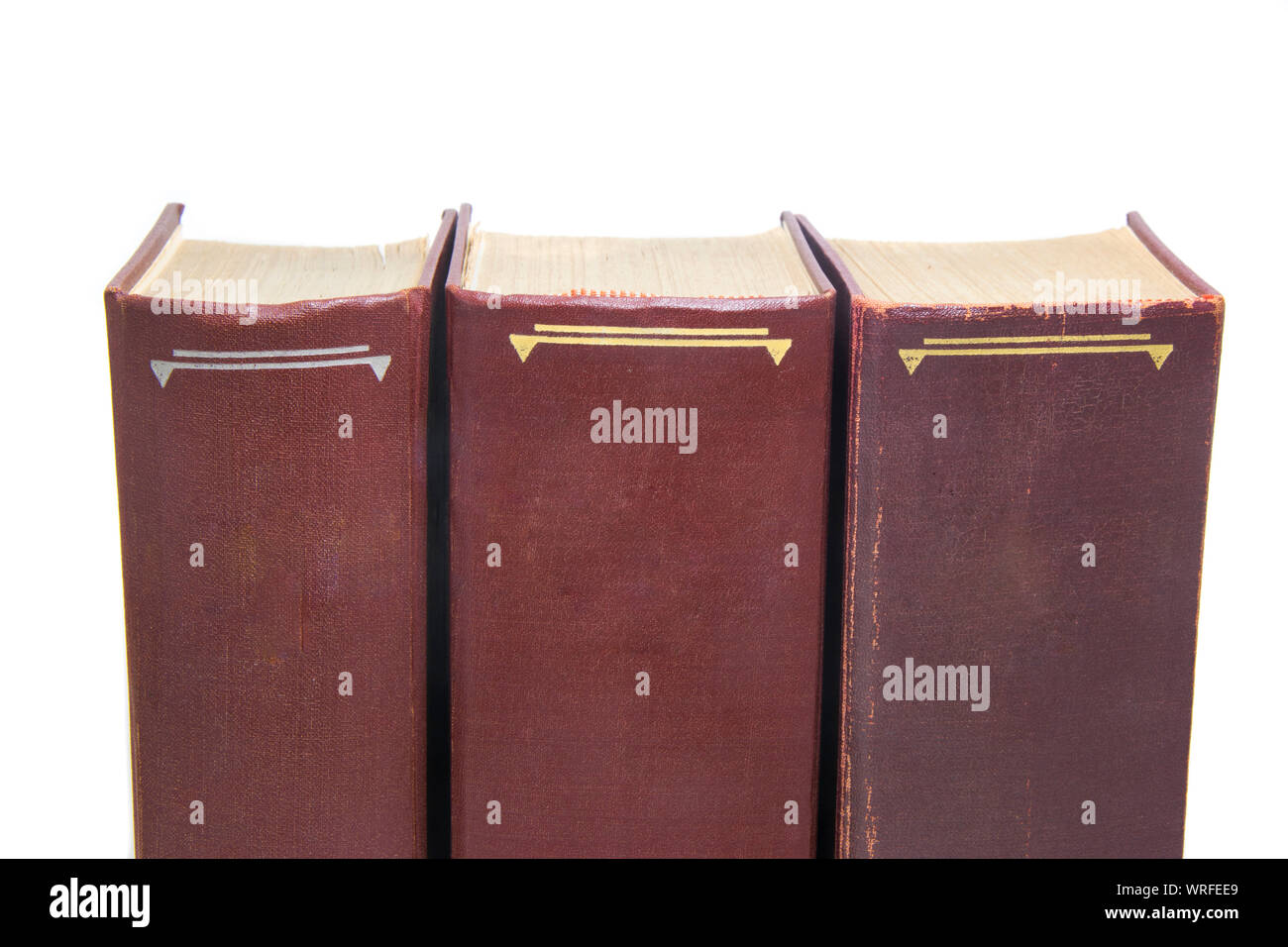 Three brown books isolated on white background Stock Photo - Alamy