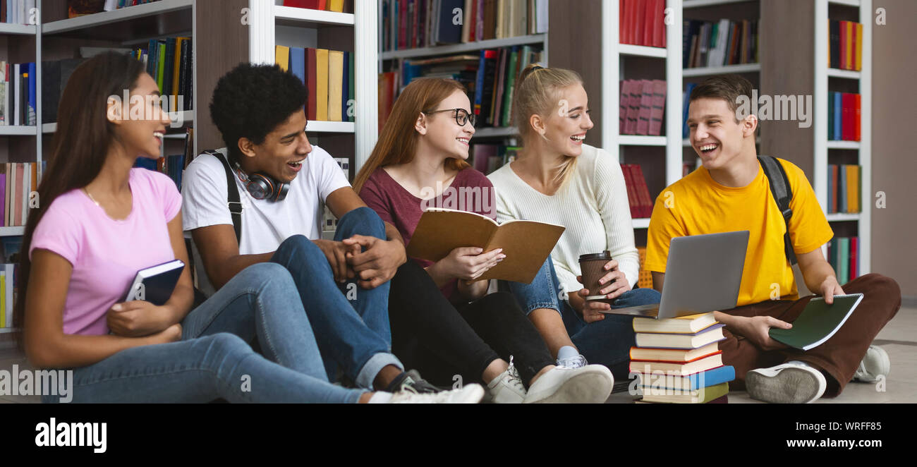 Classmates having fun while studying at campus library Stock Photo - Alamy