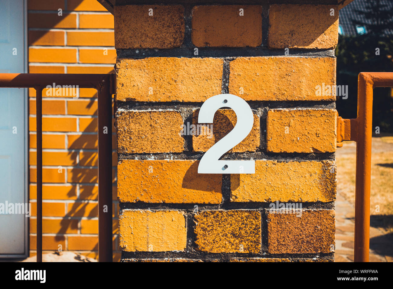 number two door sign on brick facade Stock Photo - Alamy