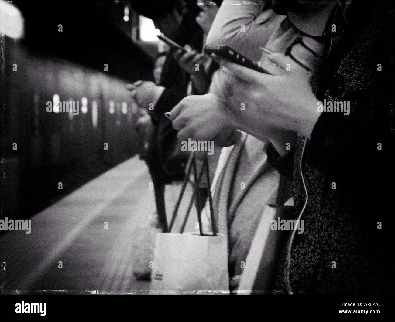 People using phones train hi-res stock photography and images - Alamy