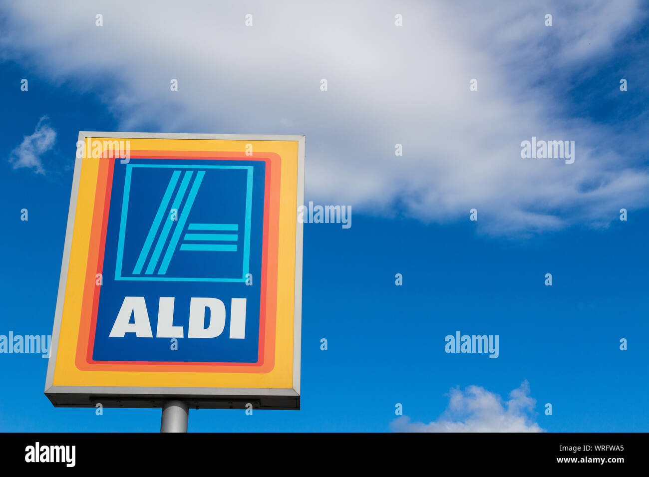 Aldi store logo against cloudy blue sky with copy space Stock Photo - Alamy