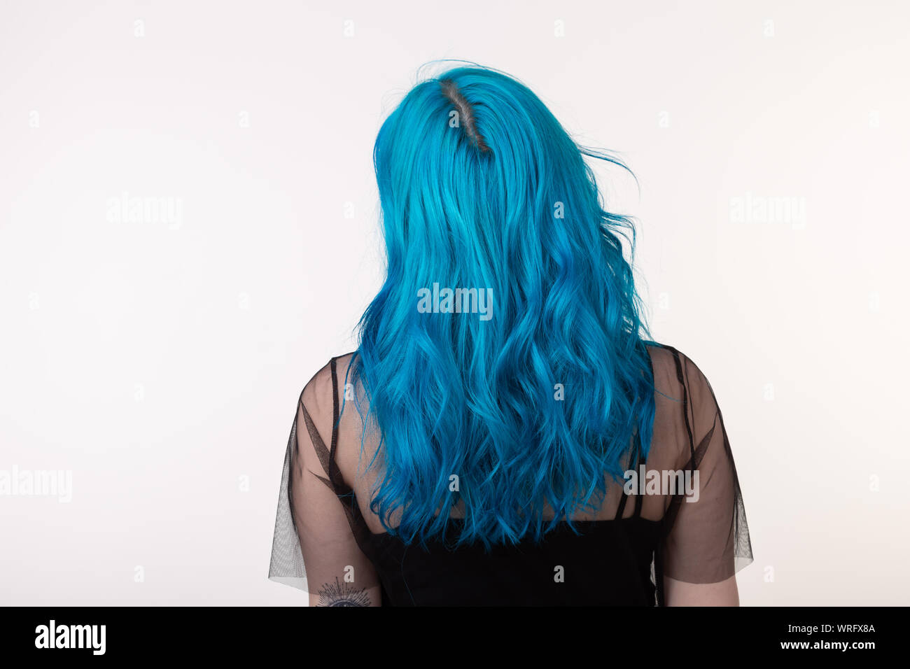 People and fashion concept - Beautiful woman with blue hair posing over ...