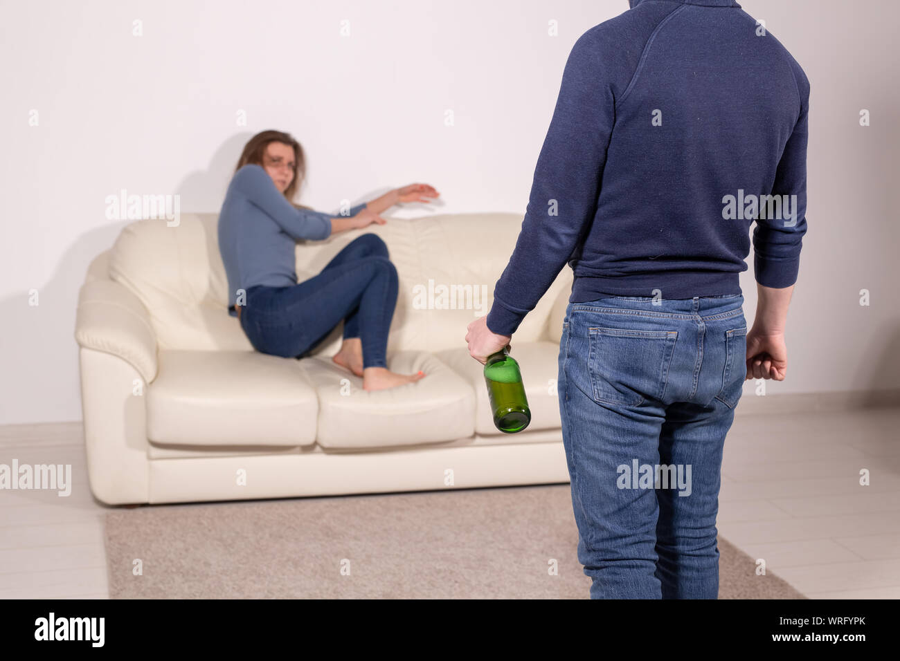 alcoholic, domestic violence and abuse concept - man gets drunk at home ...