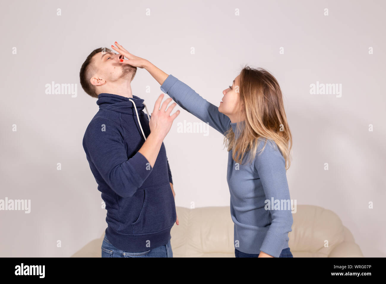 People and abuse concept - Portrait of angry young woman try to hit the ...
