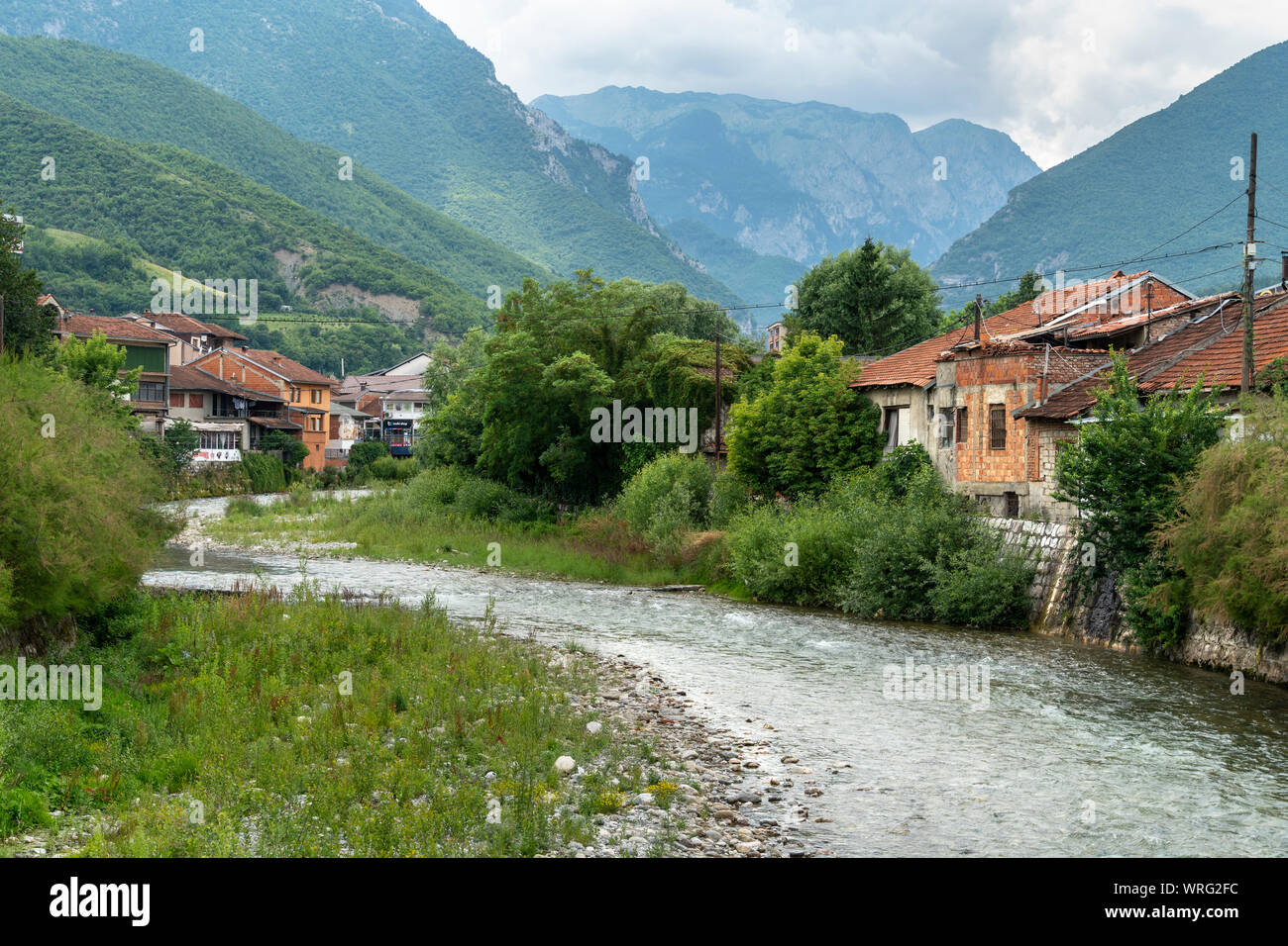 Looking across the Peć Bistrica river in the center of Pec (Peja) with ...