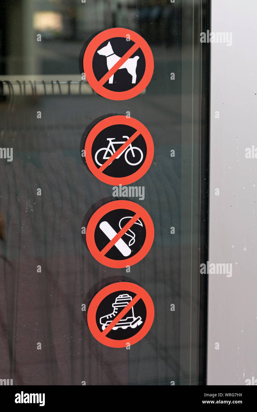 Four Restrictions Warning Signs at Glass Door Stock Photo - Alamy