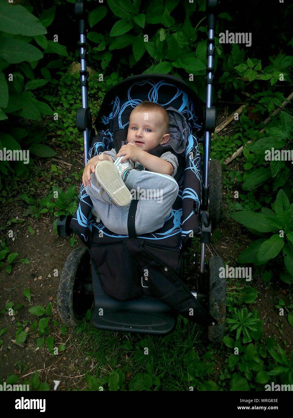 Boy with baby carriage hi-res stock photography and images - Alamy