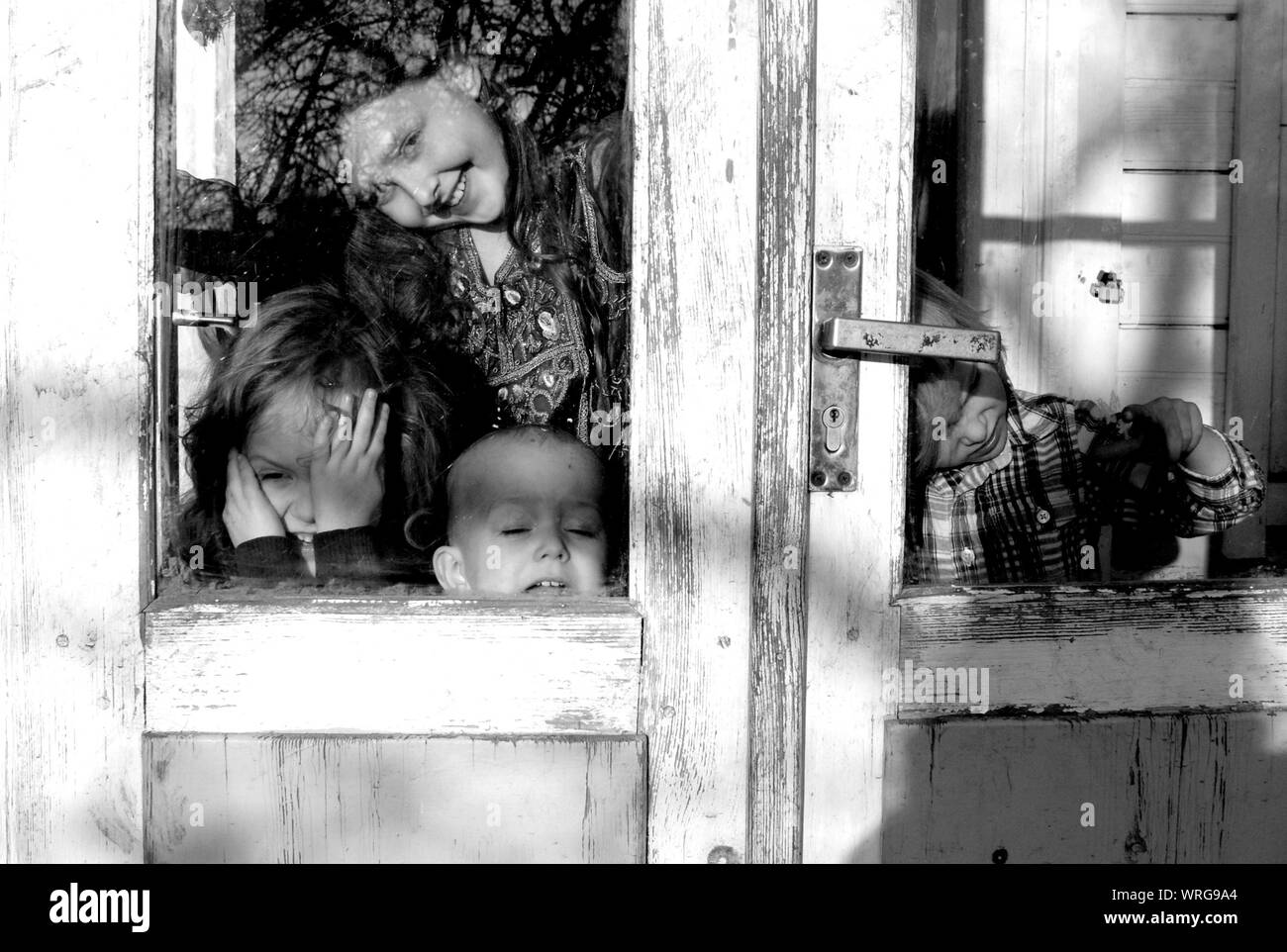 Child looking through house window Black and White Stock Photos ...