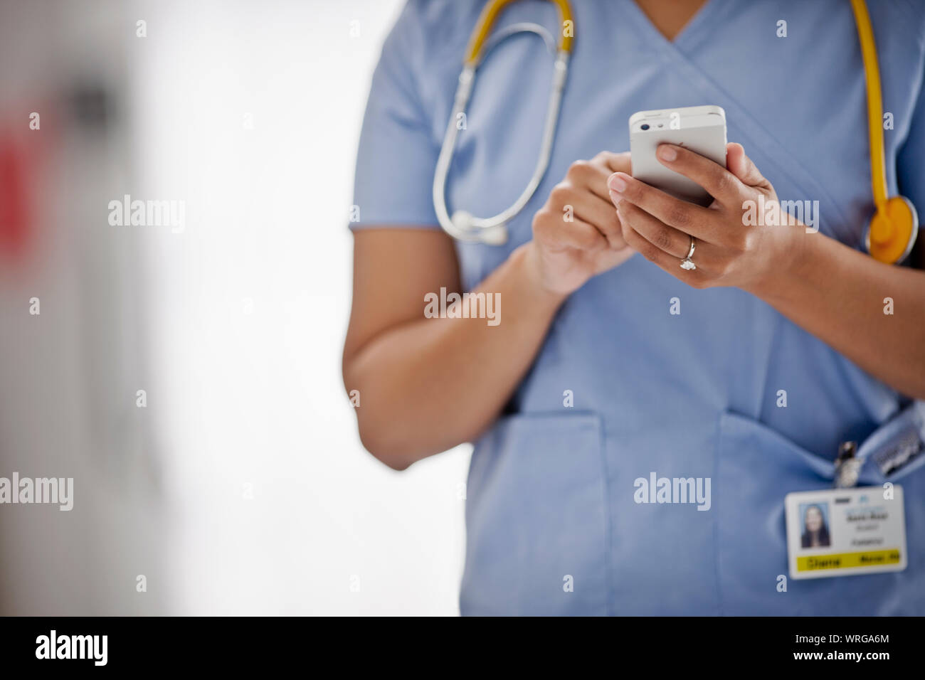 Young nurse using a cell phone Stock Photo - Alamy