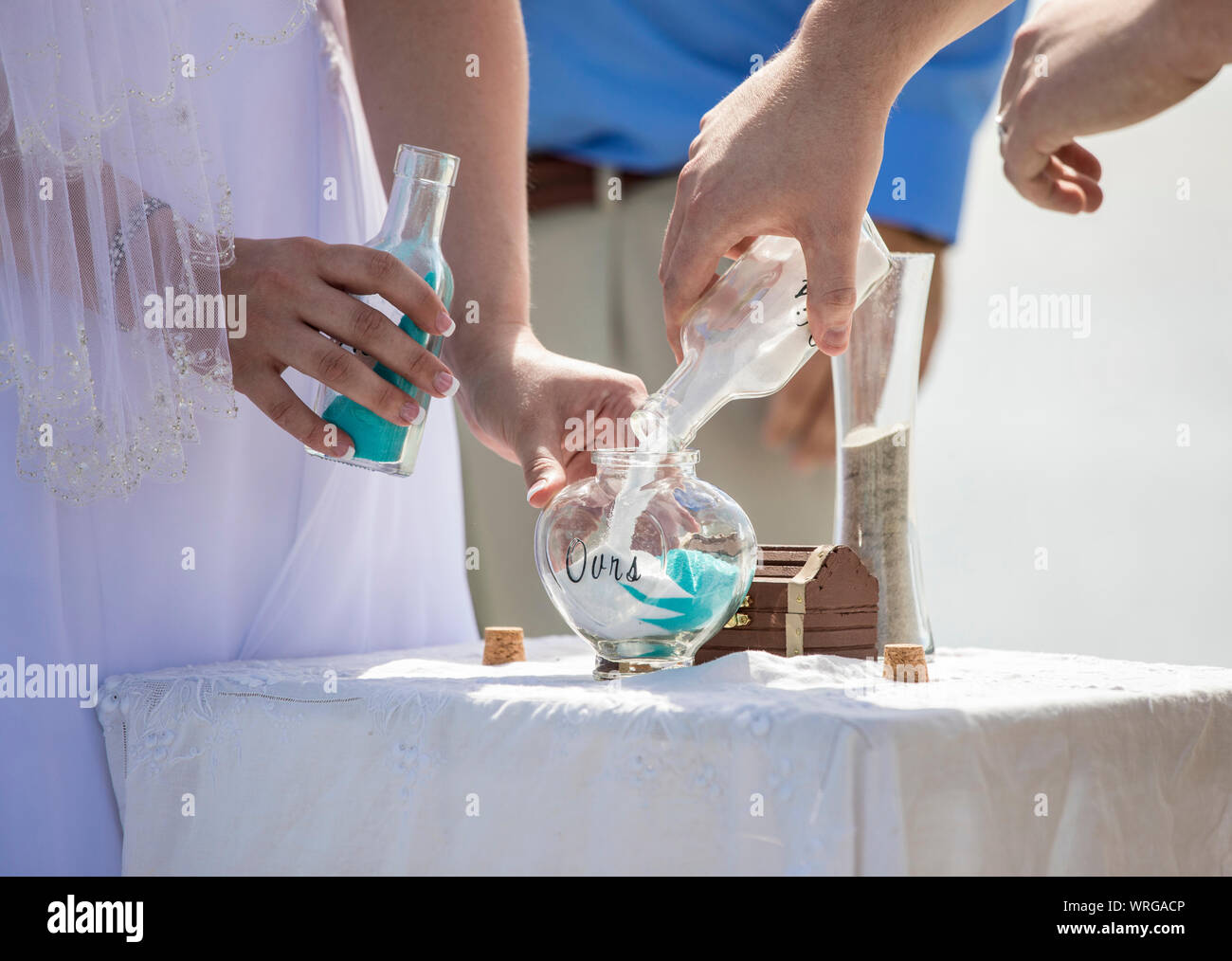 Detail shot of hands pouring sand at wedding for sand ceremony Stock ...