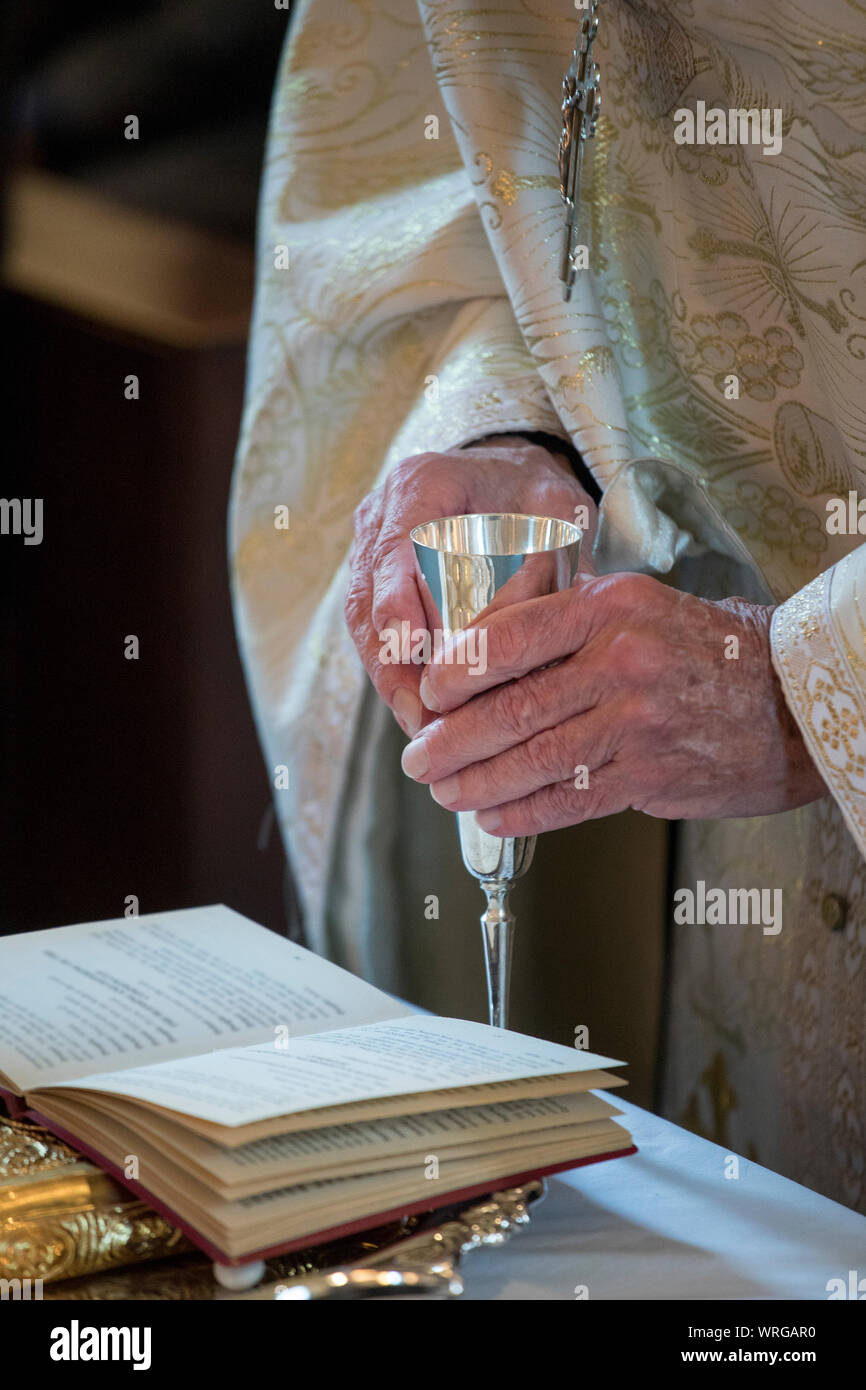 hands of Greek Orthodox priest holding communion chalace Stock Photo ...