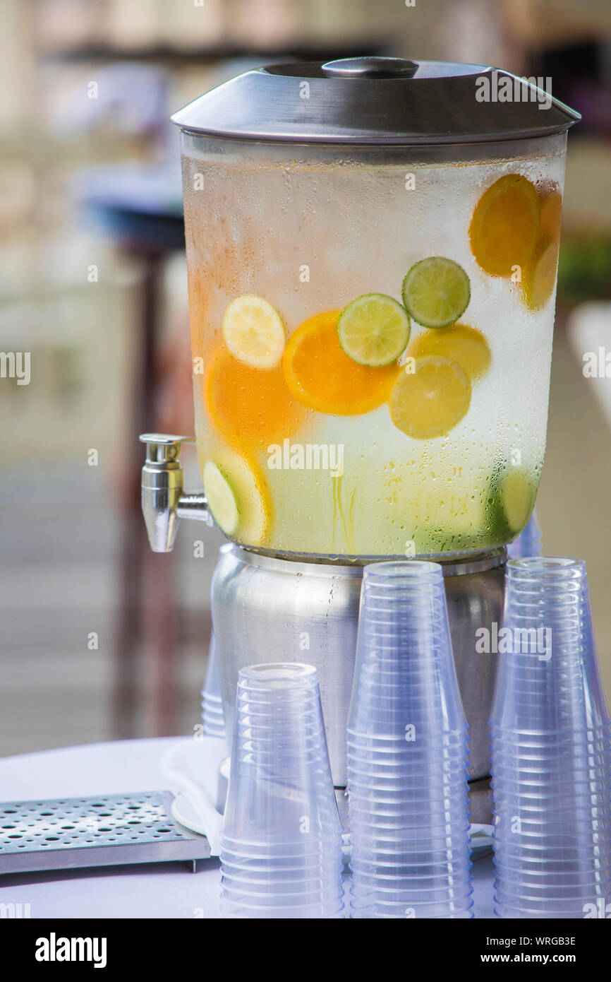 Large container of cold fruit infused water for reception Stock Photo ...
