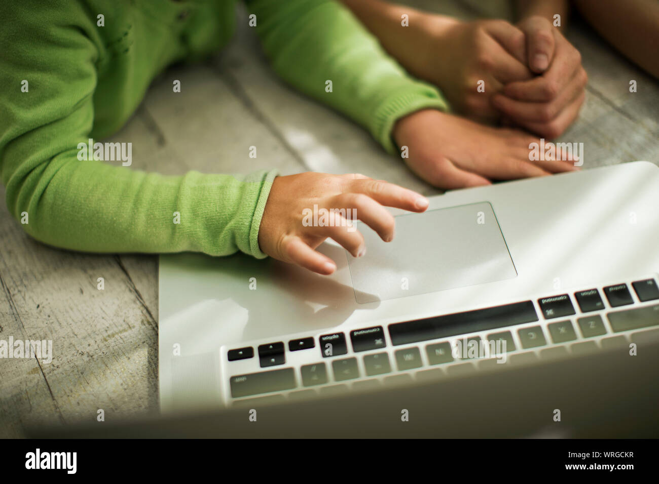 Hand of a young girl typing on a laptop computer Stock Photo - Alamy