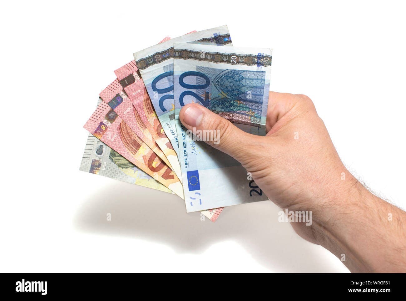 Human hand holding euros isolated on white background Stock Photo - Alamy