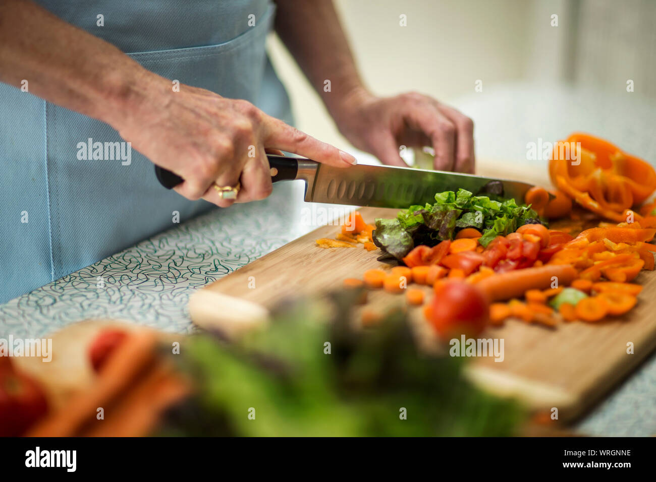 Woman cutting fresh vegetables Stock Photo - Alamy