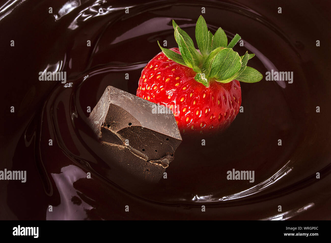 Strawberry in chocolate and hot chocolate liquid Stock Photo - Alamy