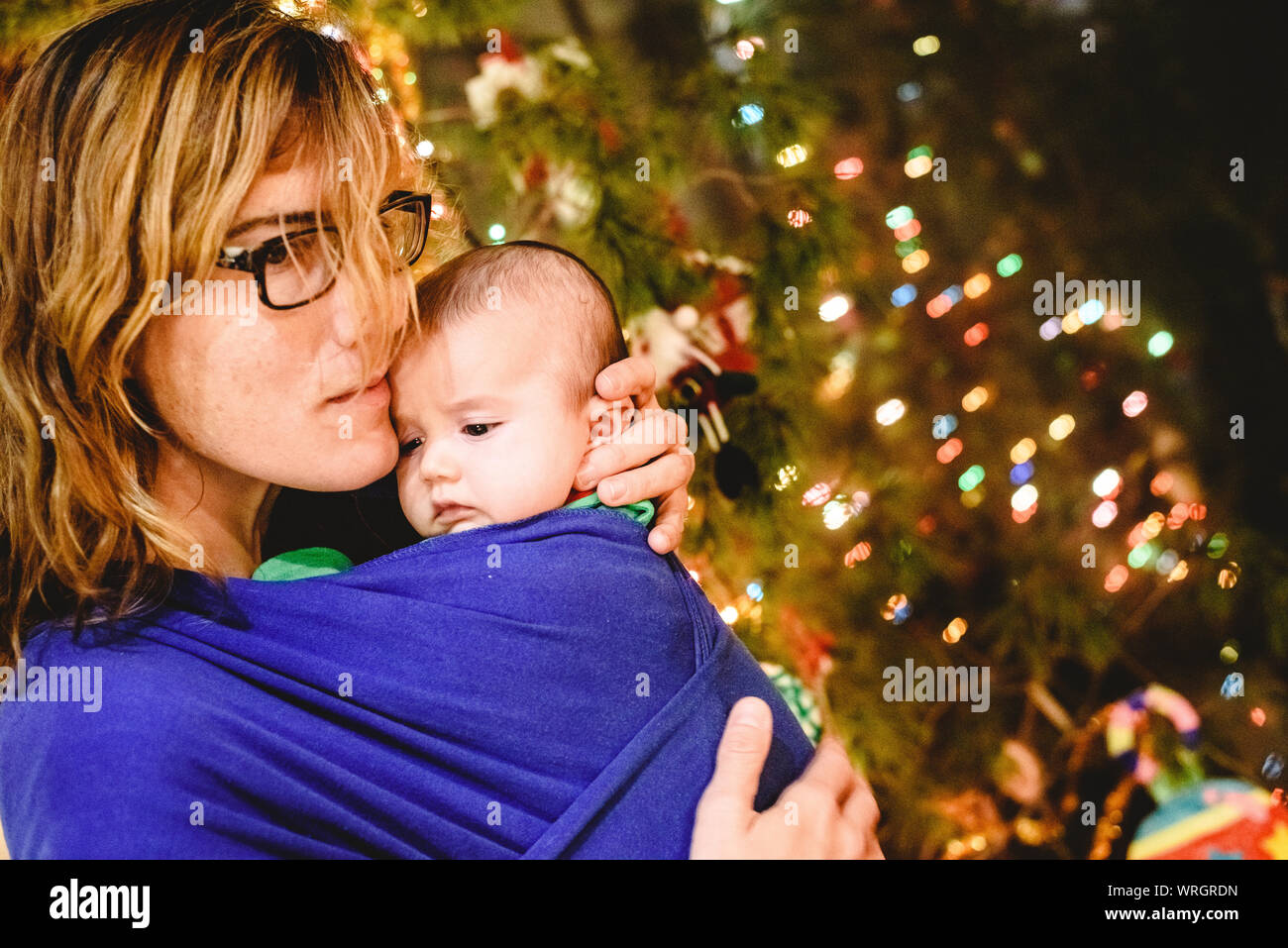 Newborn baby portaged by his mother in a traditional scarf Stock Photo ...