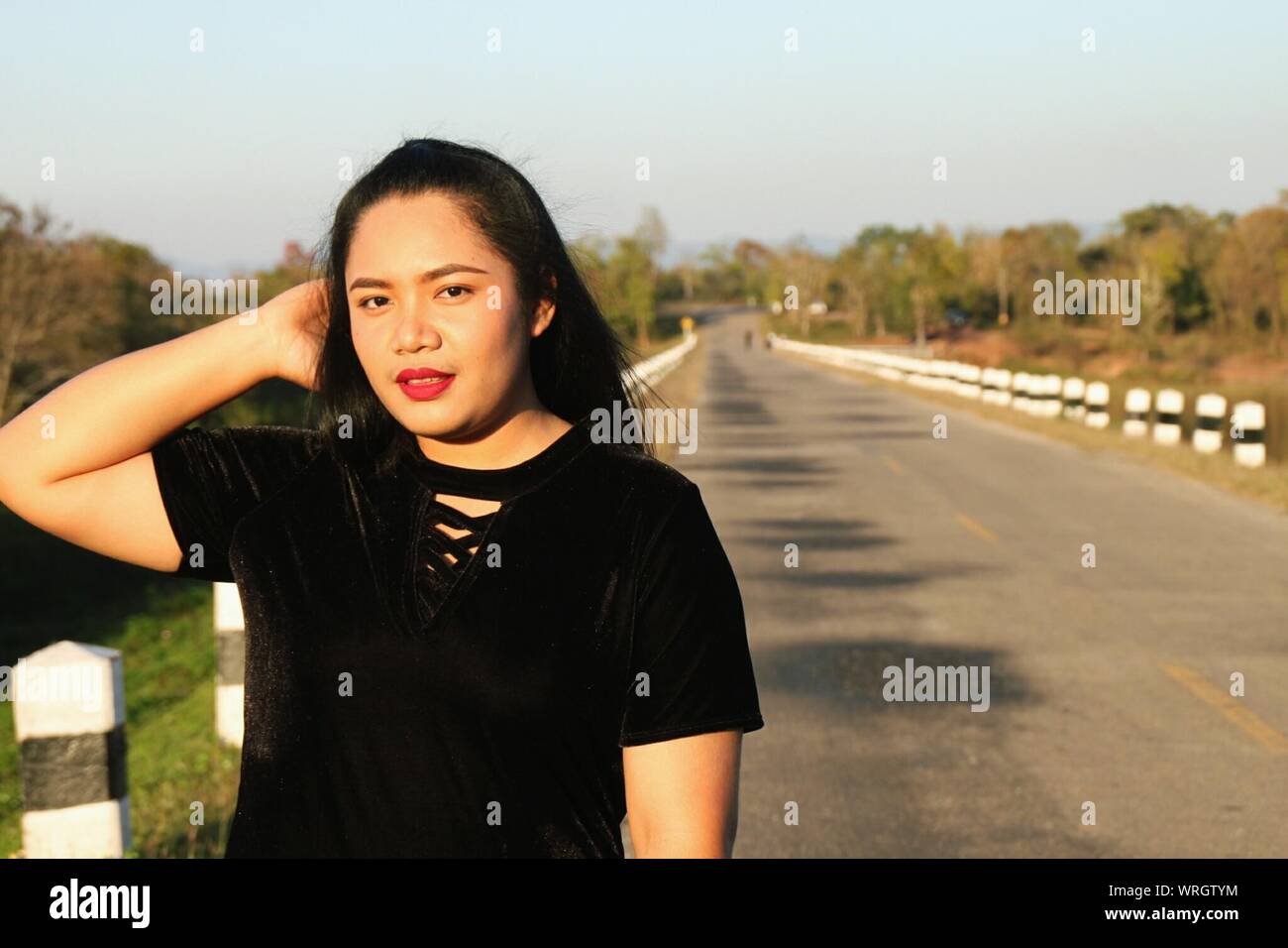 Woman standing roadside hi-res stock photography and images - Alamy