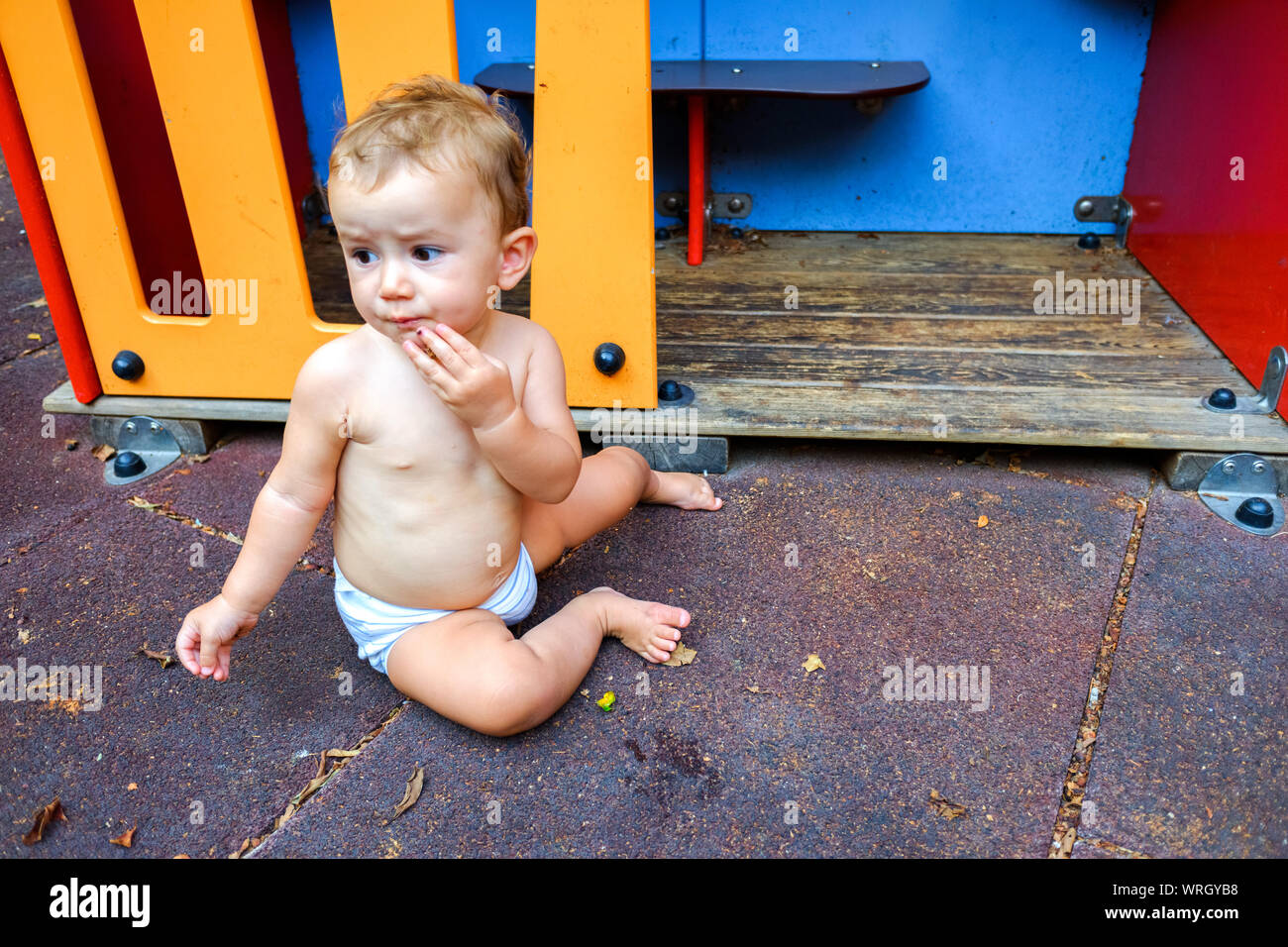 Baby playing in a playground Stock Photo - Alamy