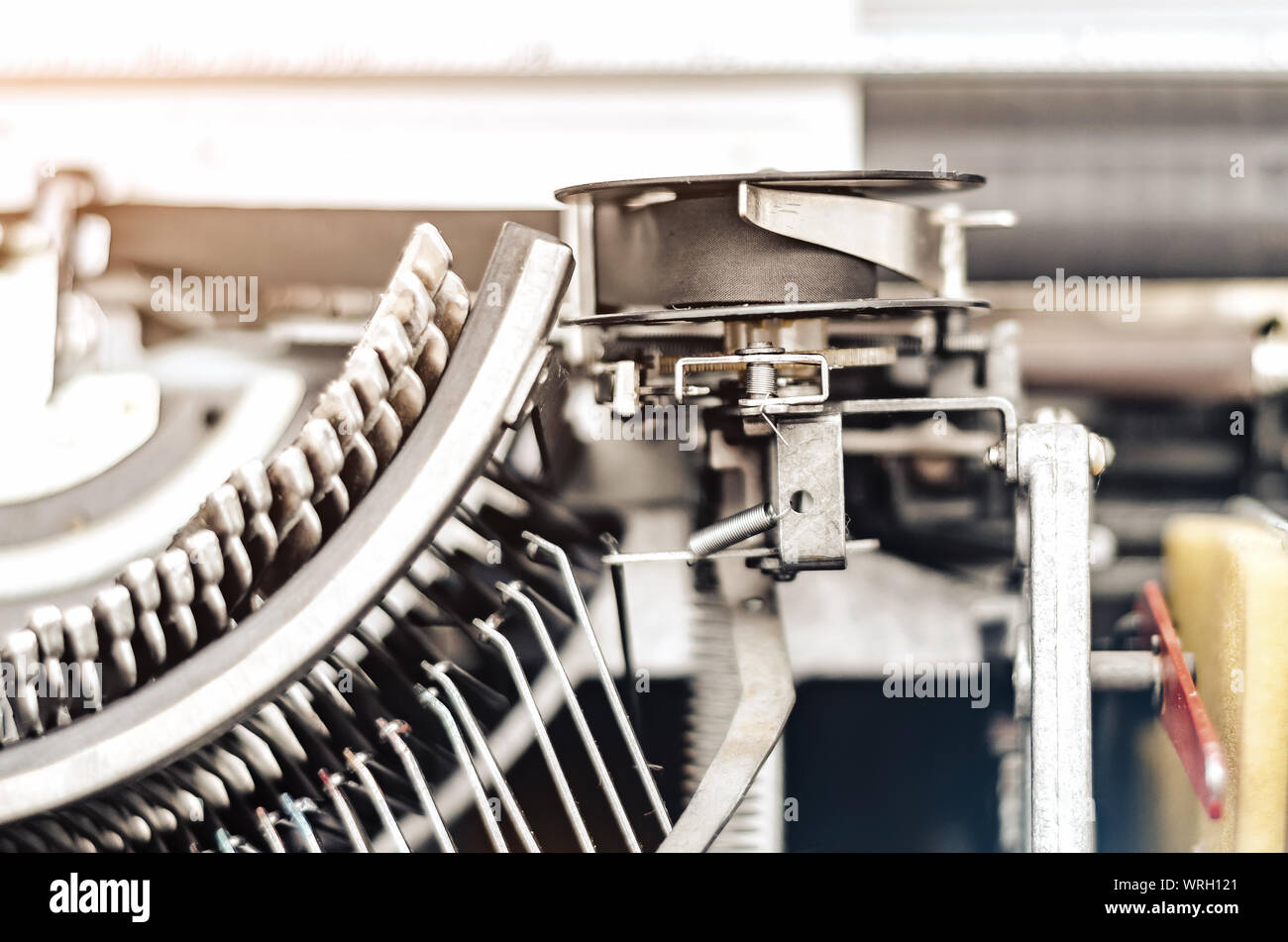 Carriage block with letters in an old mechanical typewriter. Close-up ...