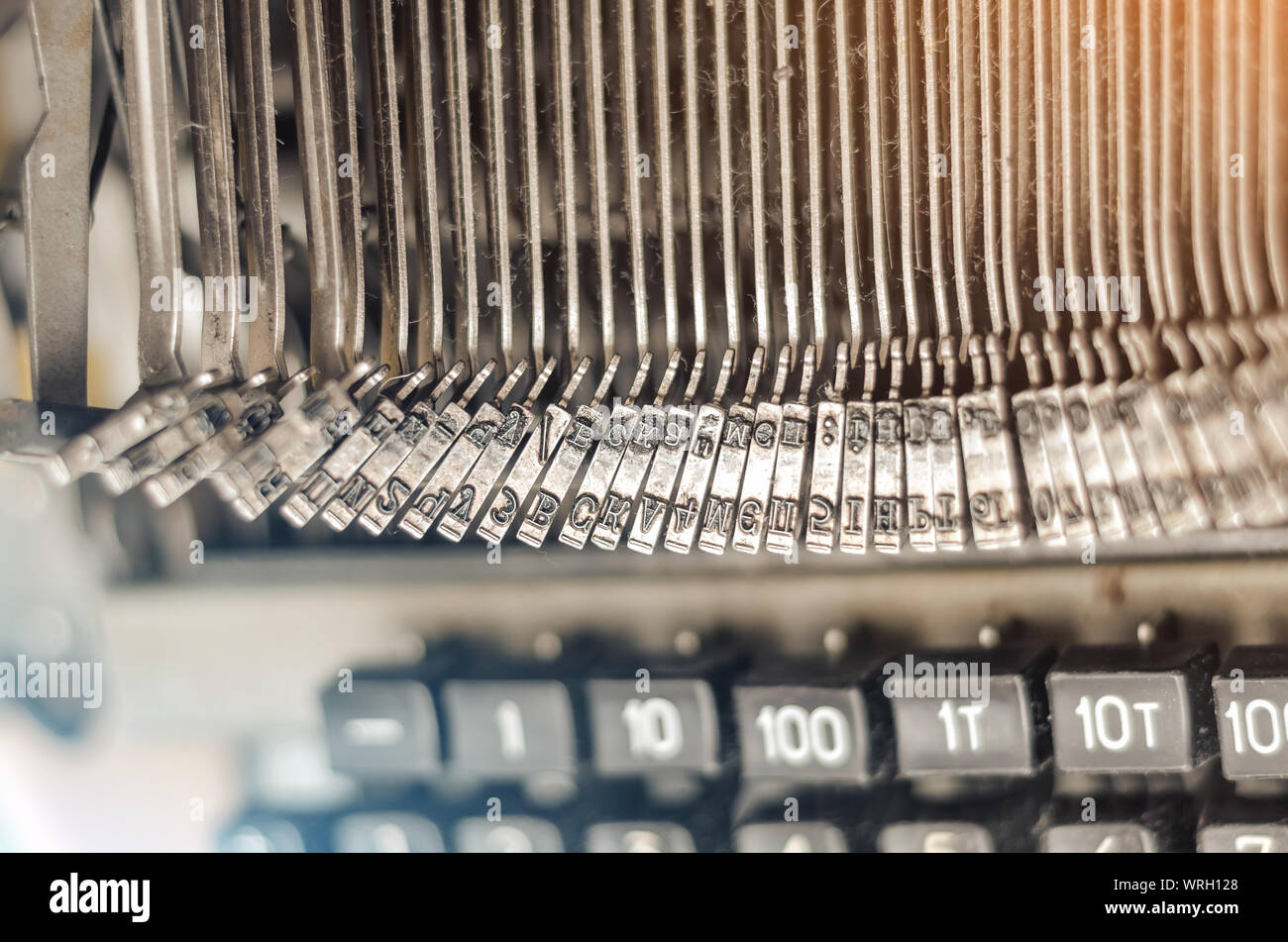 Carriage block with letters in an old mechanical typewriter. Close-up ...
