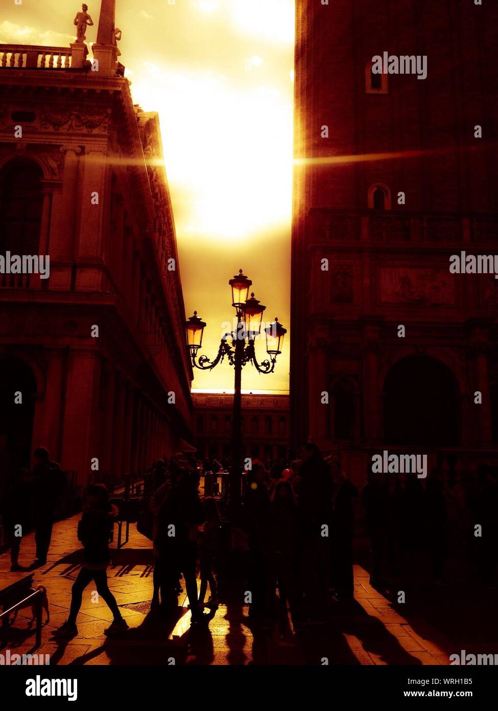 Sun between building hi-res stock photography and images - Alamy