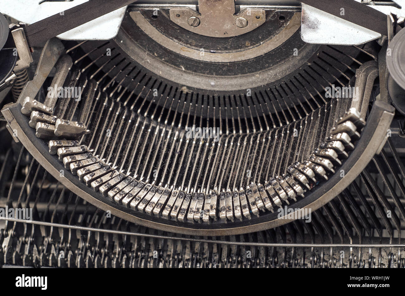 Carriage block with letters in an old mechanical typewriter. Close-up ...