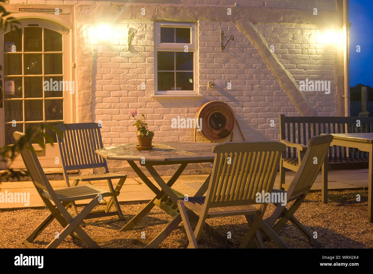 Seating area in the evening outside the Peacock Country Inn with wooden ...