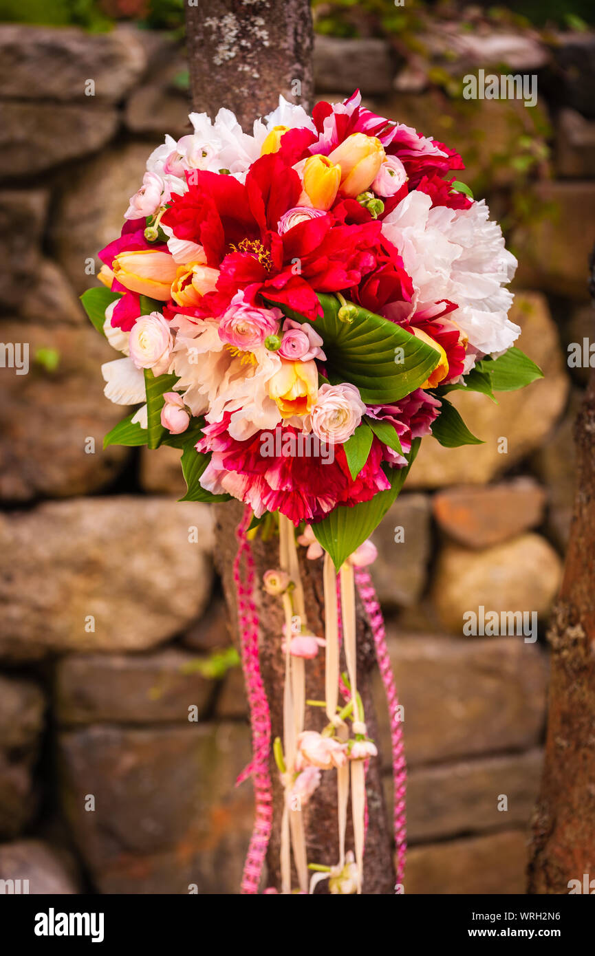 Colorful floral flower bouquet tied to a tree Stock Photo - Alamy