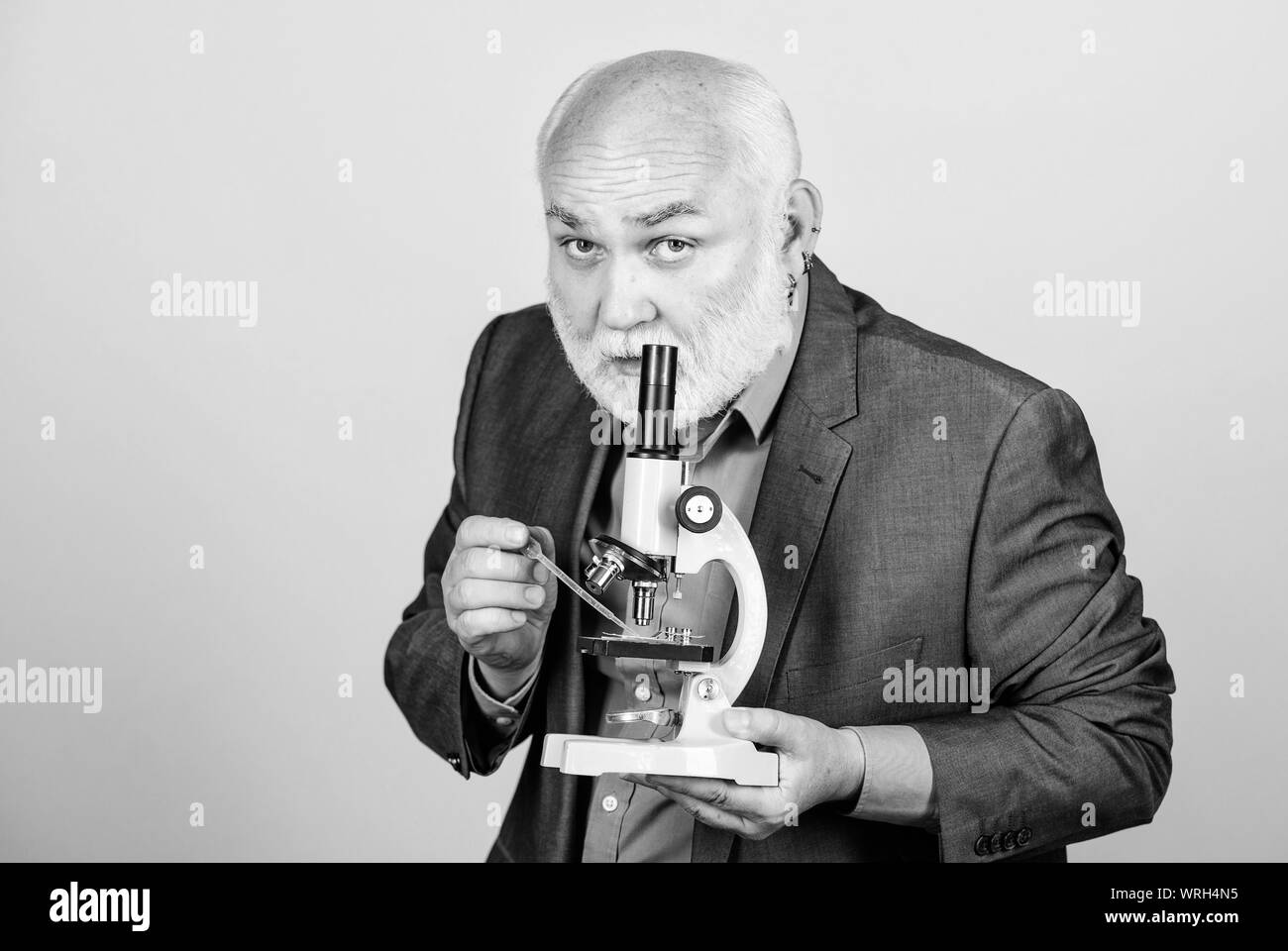 Doing research. chemistry in school laboratory. mature bearded teacher ...