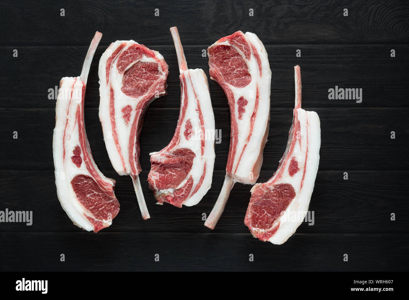 Top view of five raw fatty lamb chops on a dark background Stock Photo ...