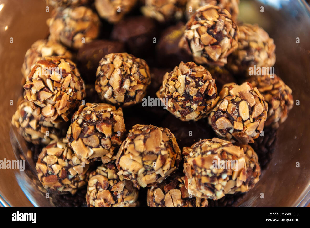 A bowl of round nut covered candies Stock Photo - Alamy
