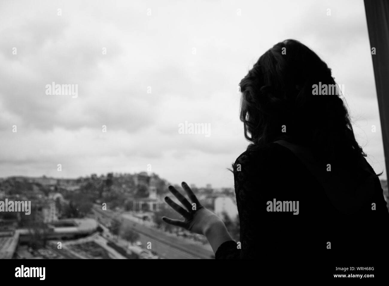Rear view of women looking out window Black and White Stock Photos ...