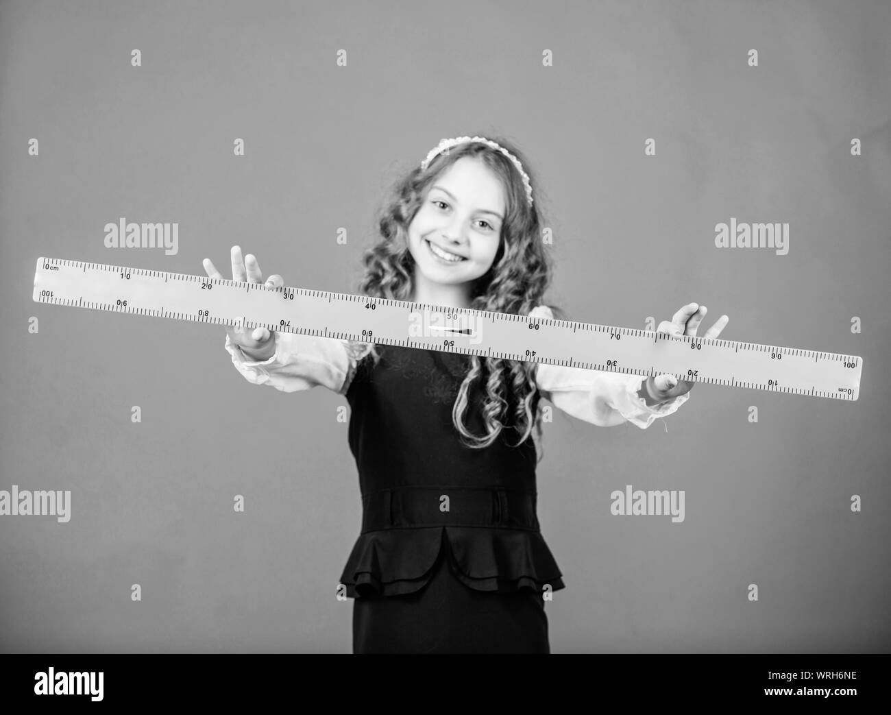 Kid school uniform hold ruler. Pupil cute girl with big ruler. Geometry ...